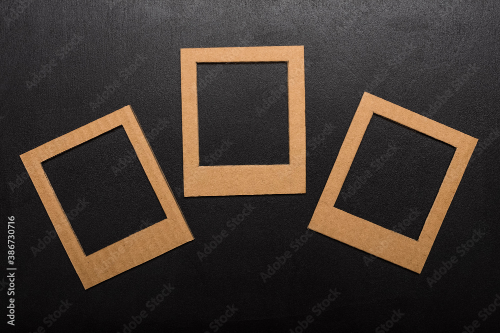 three frames for photos. Kraft cardboard square frame template on black ...