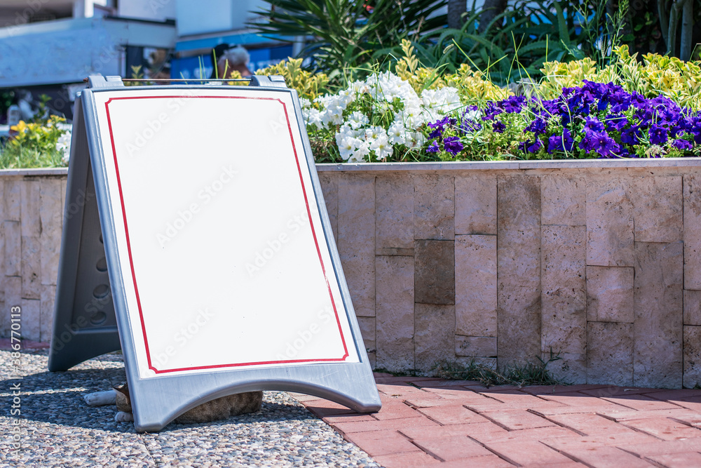 blank white signboard with mockup in red frame on sidewalk of city ...