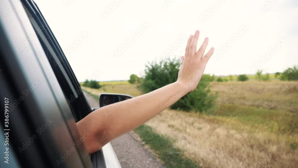 happy free girl put her hand out and in the car window. concept travel ...