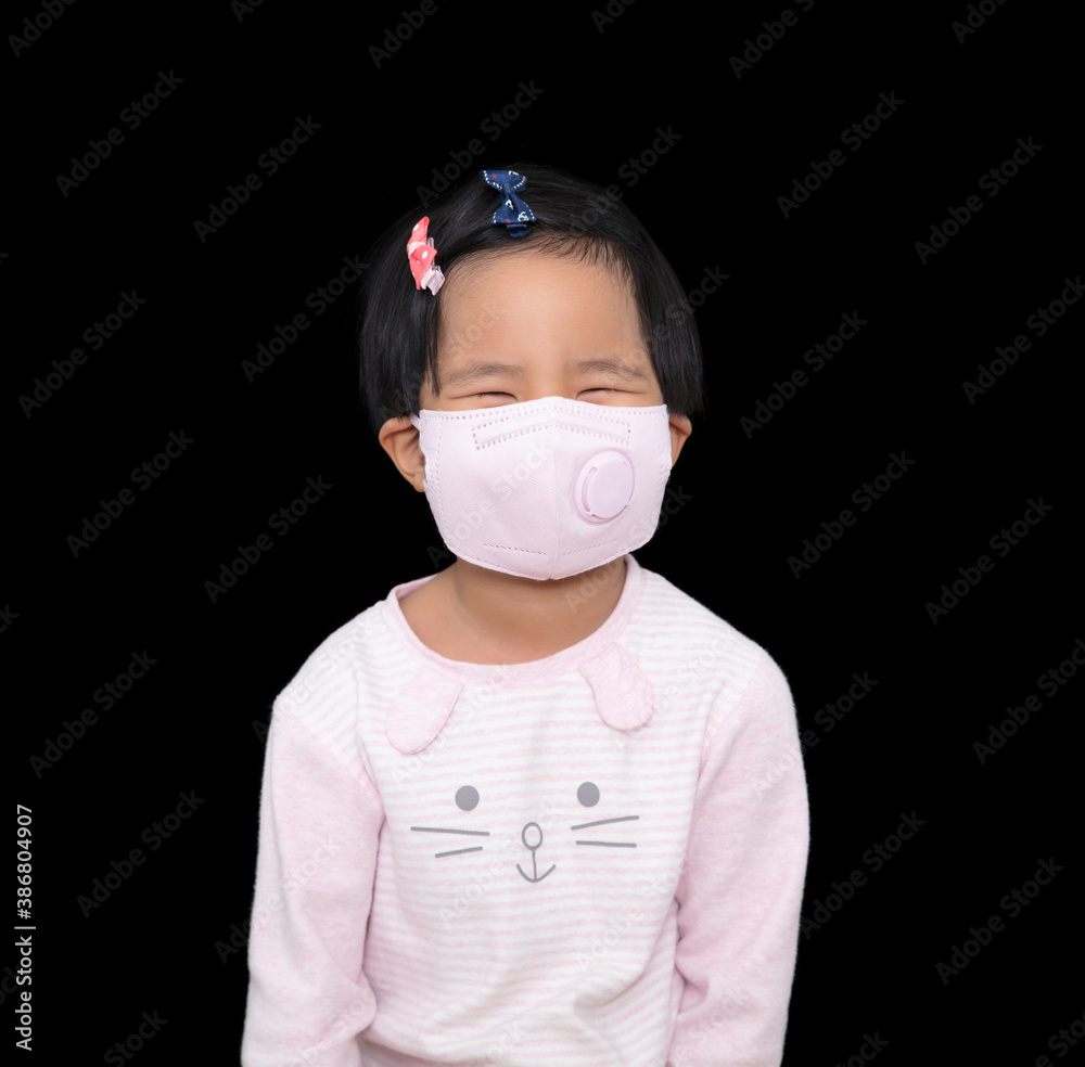 Little girl wearing a mask in front of black background Stock Photo ...