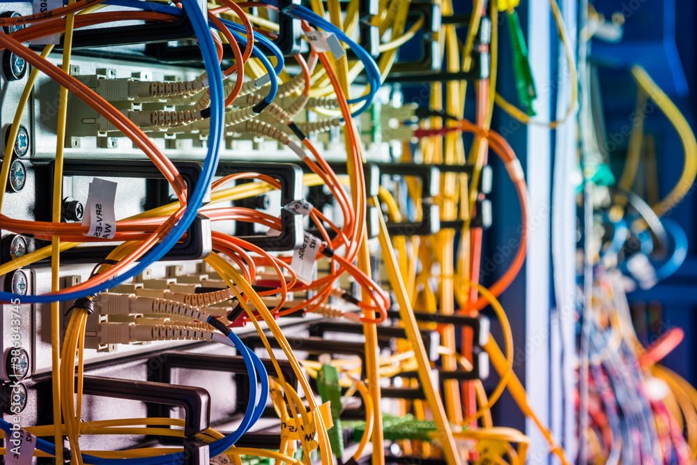 Server rack with fiber optic cables attached to front panel swit Stock ...