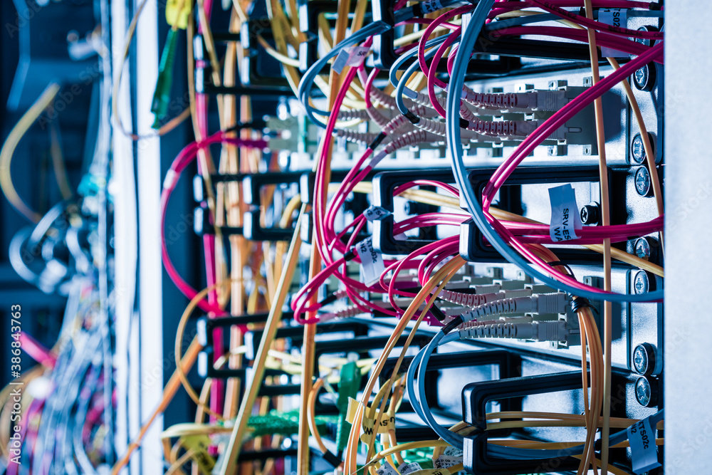 Server rack with fiber optic cables attached to front panel swit Stock ...