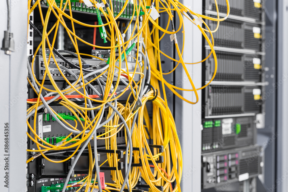 Server rack with fiber optic cables attached to front panel swit Stock ...