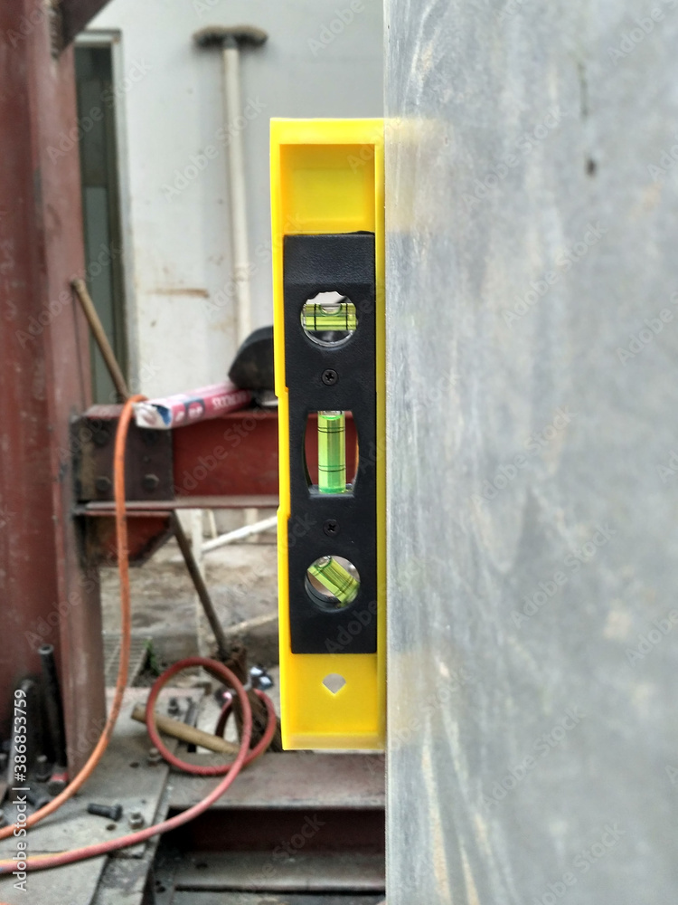 building level. Steel Construction. The waterpass level lies on sheel ...