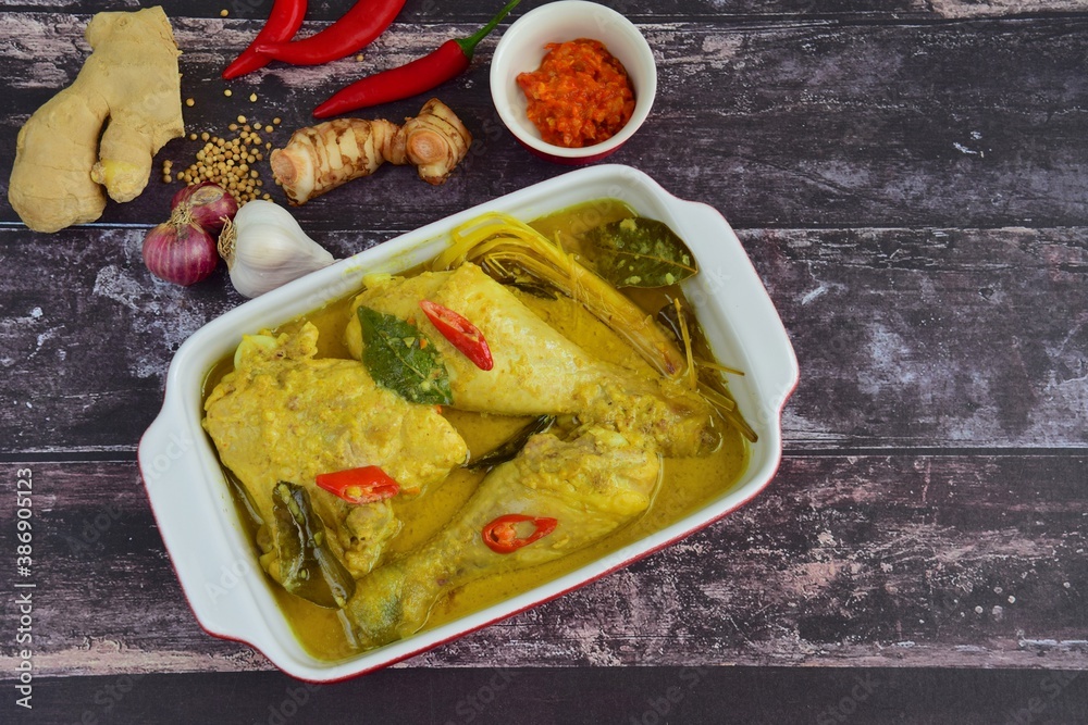 Opor ayam, chicken cooked in coconut milk and spices, originated from Central Java, Indonesia ...
