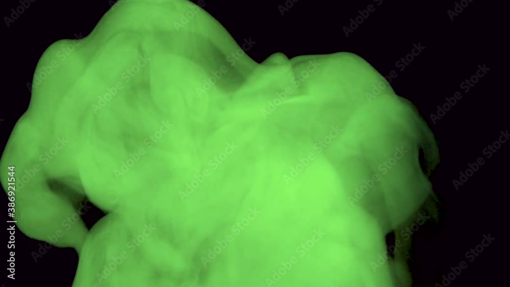 Green smoke on a black background. Slow motion. Toxic smoke. Fog ...