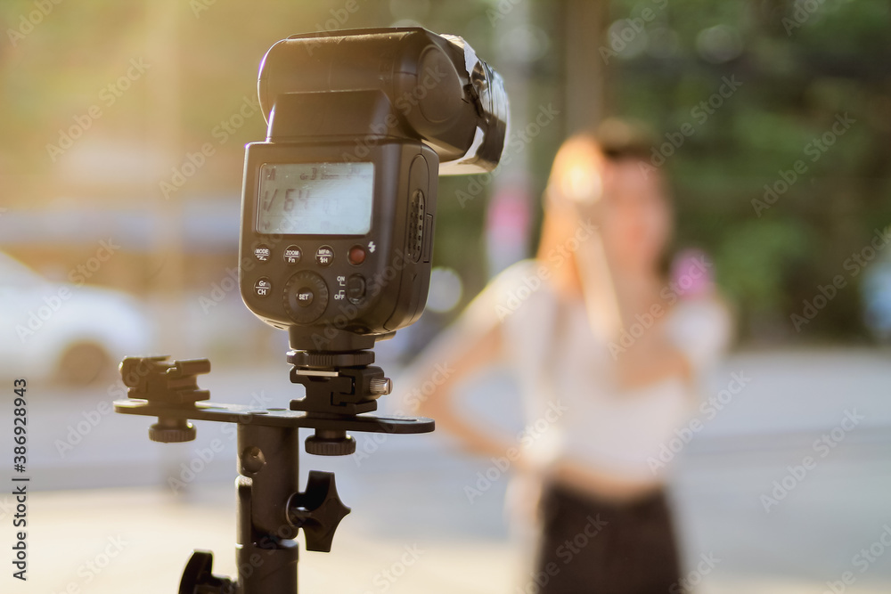 A group of photographers is recording the model using a separate flash ...
