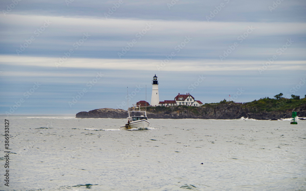 Beautiful Portland Head Light lighthouse with cliffs and coast line of ...