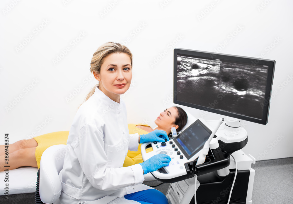 Portrait of woman ultrasound doctor during ultrasonography procedure ...