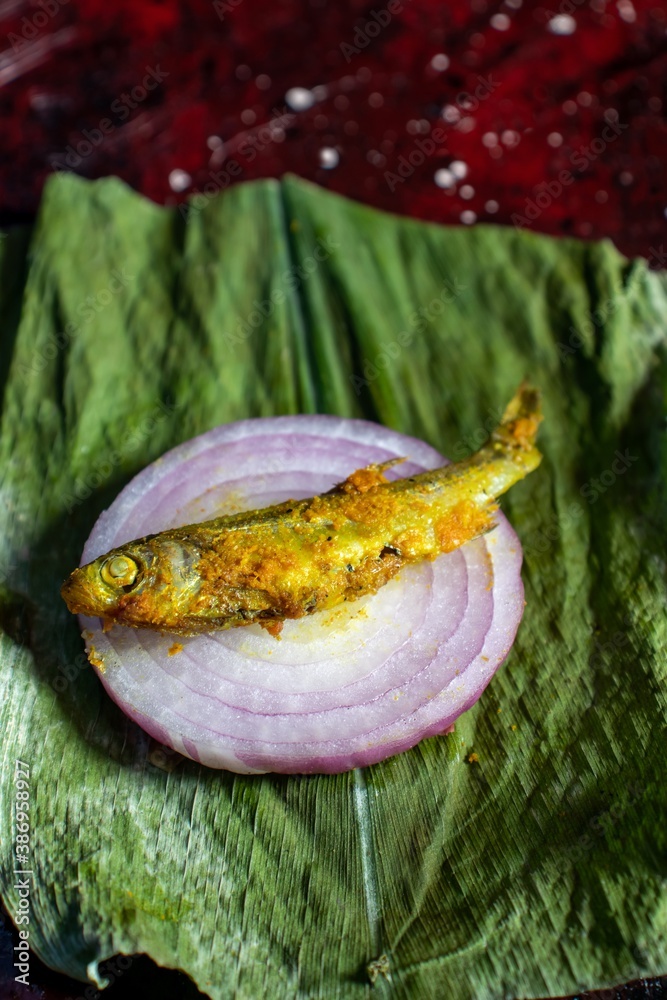 Closeup of Cooked Mourala Fish or Indian Carplet Fish on Onion Slice in ...