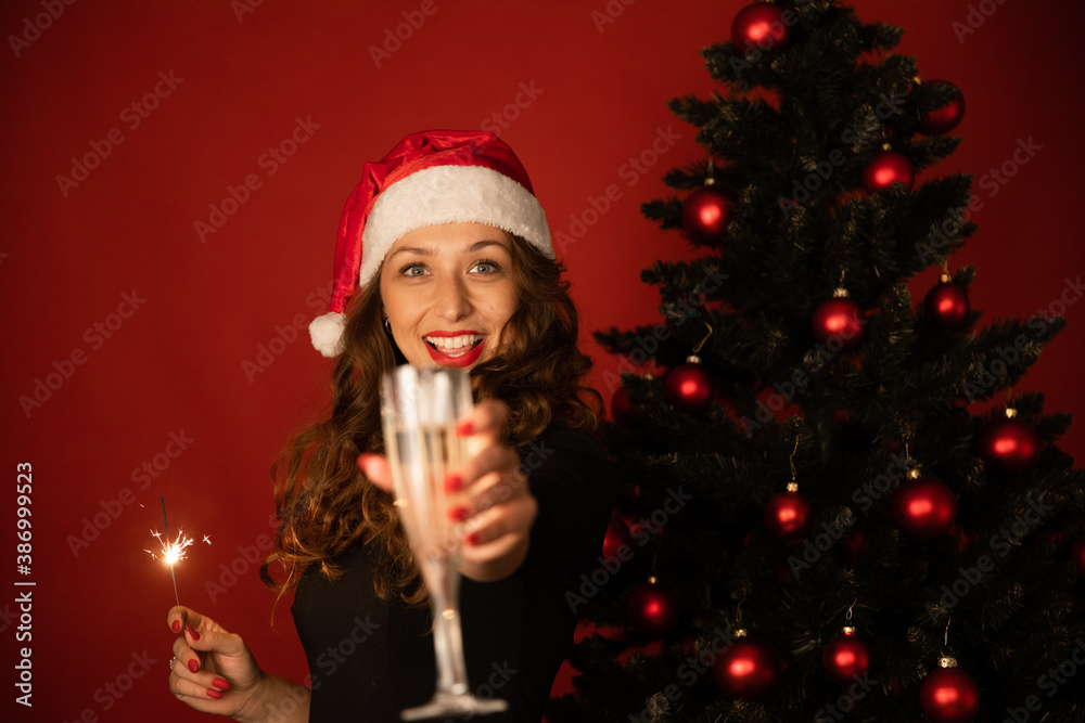 Beautiful long-hair brunette girl in Santa Claus hat distant celebrates ...