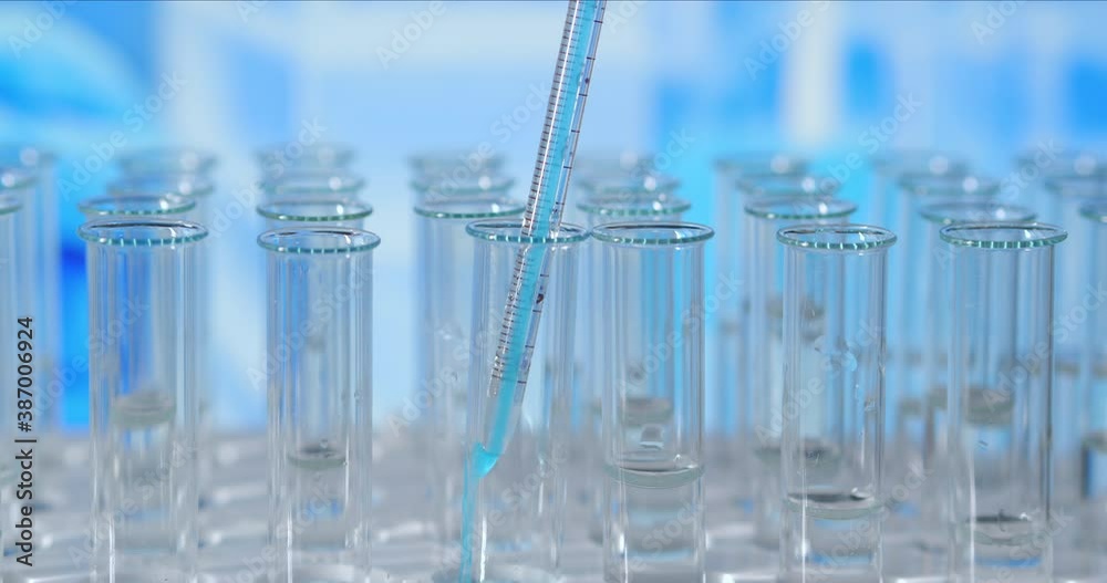 scientist with a pipette analyzes a liquid to extract the DNA and ...