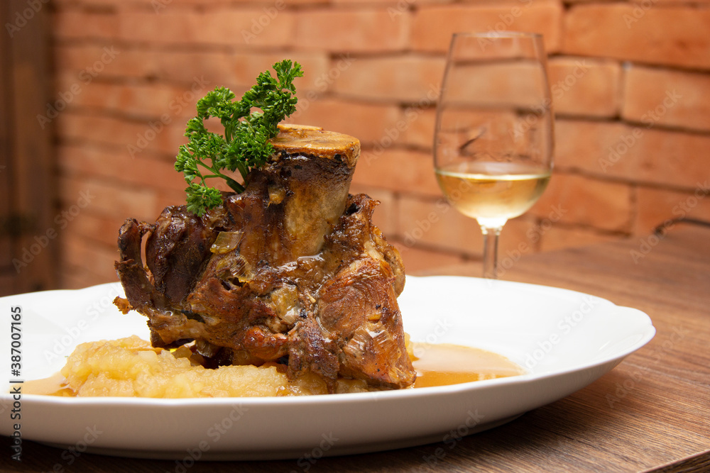Stinco pork with green apple puree. Traditional Eisbein. harmonized ...