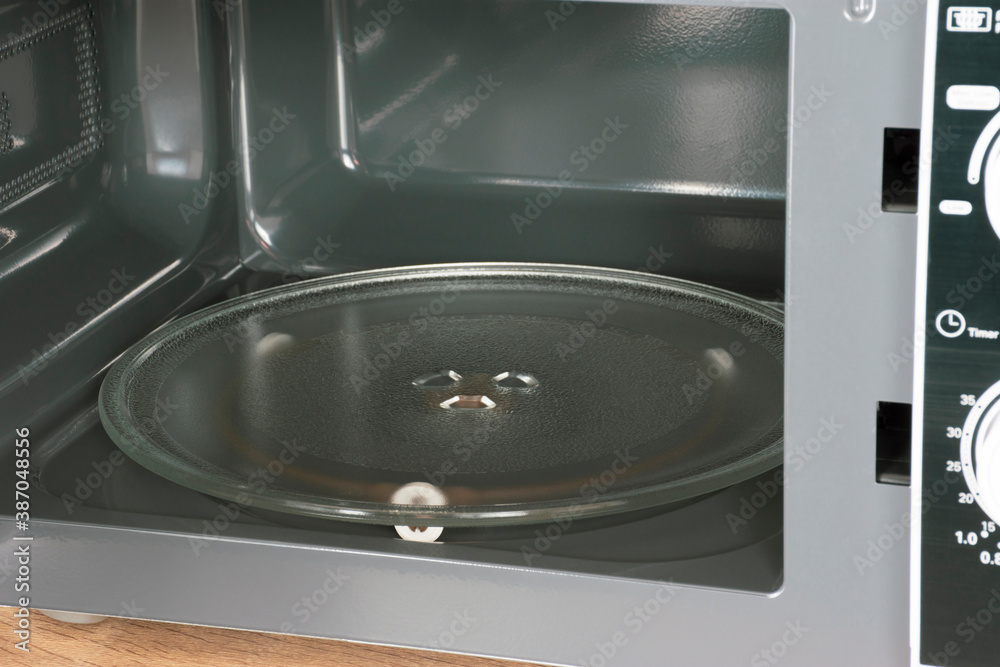 Empty microwave turntable glass tray inside of the microwave oven Stock ...