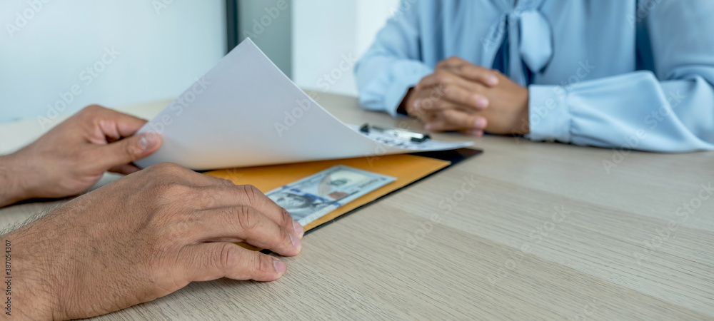 The hands of businessmen who bribe government officials to sign ...