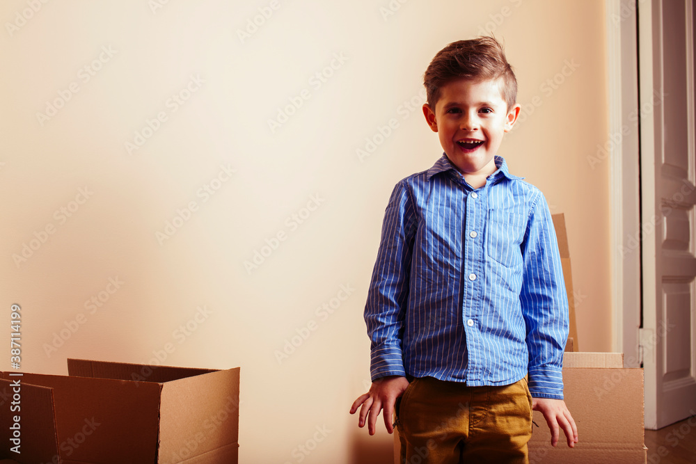 little cute boy in empty room, move to new house. home alone among ...