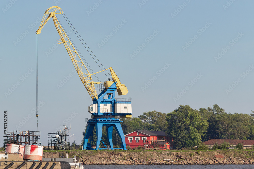 Foto de large port crane in the docks lifts structures. Cargo ...