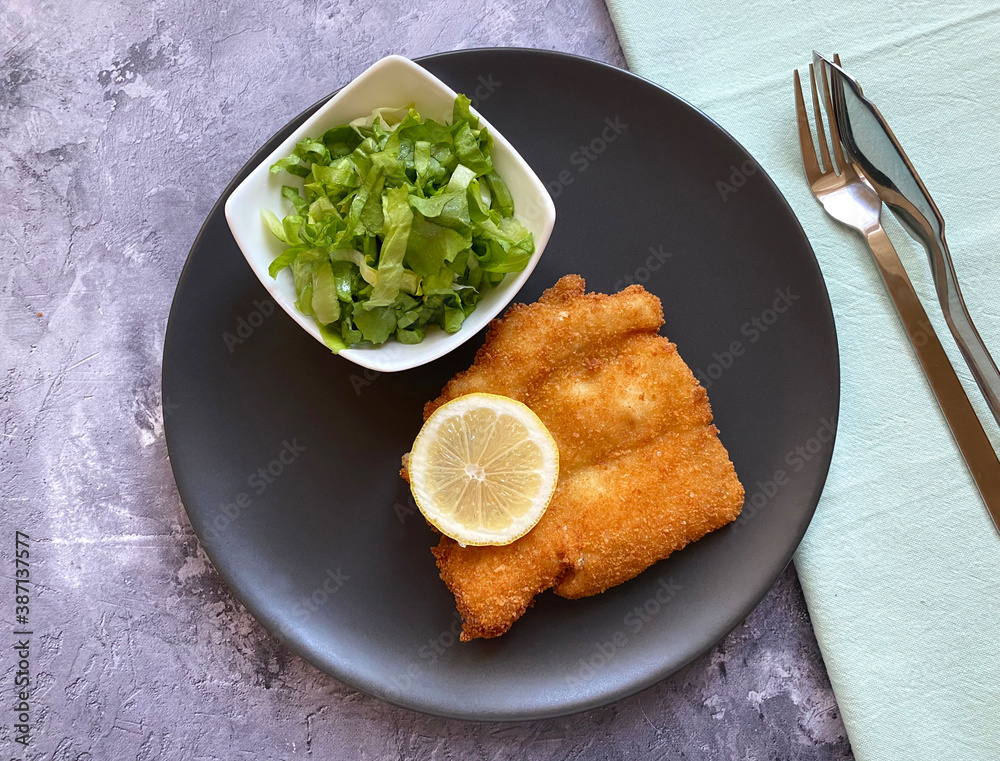 Breaded cod fish fillet, also known as Kabeljau. The fish is coated in ...