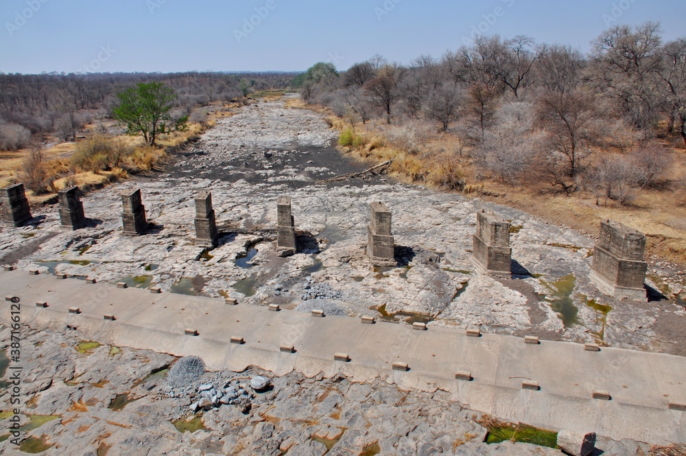 Old destroyed bridge and concrete ferry for cars over a dried river in ...