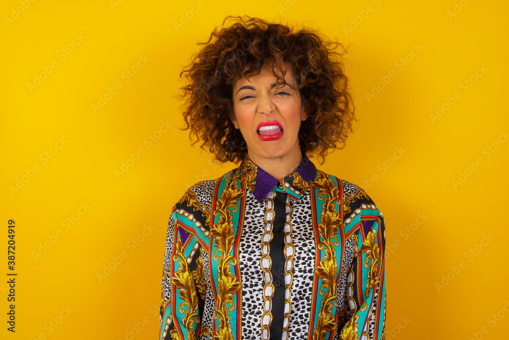 Body language. Disgusted stressed out pretty girl posing against gray ...