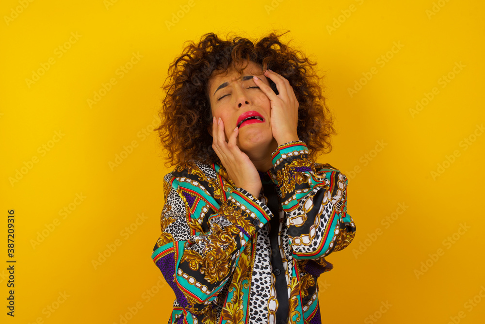 Young gloomy woman, hiding her face with hands pouting and crying ...