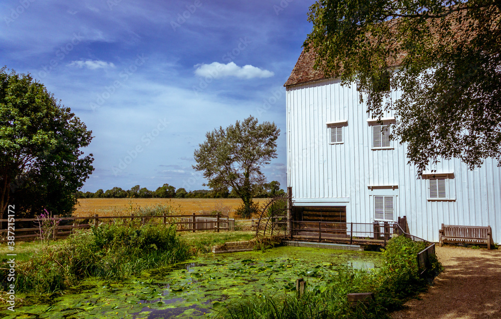 Classic exterior of an old English barn and watermill Stock Photo ...