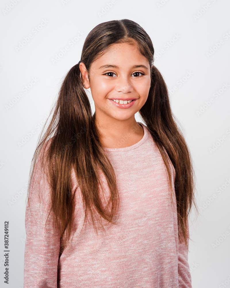 Happy cute smiling casual girl 8-10 years old standing against white ...