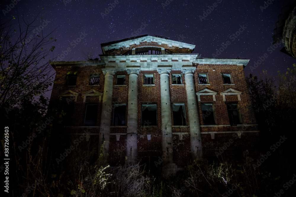 Dark and creepy old abandoned haunted mansion at night. Former Kostrov ...