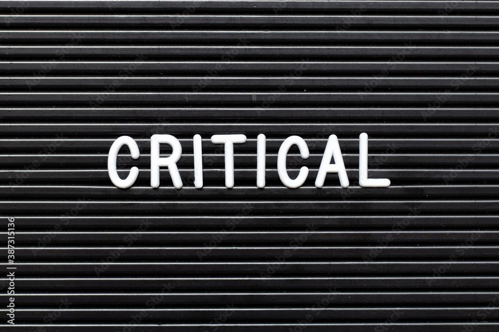 Black felt board with white alphabet in word critical background Stock ...