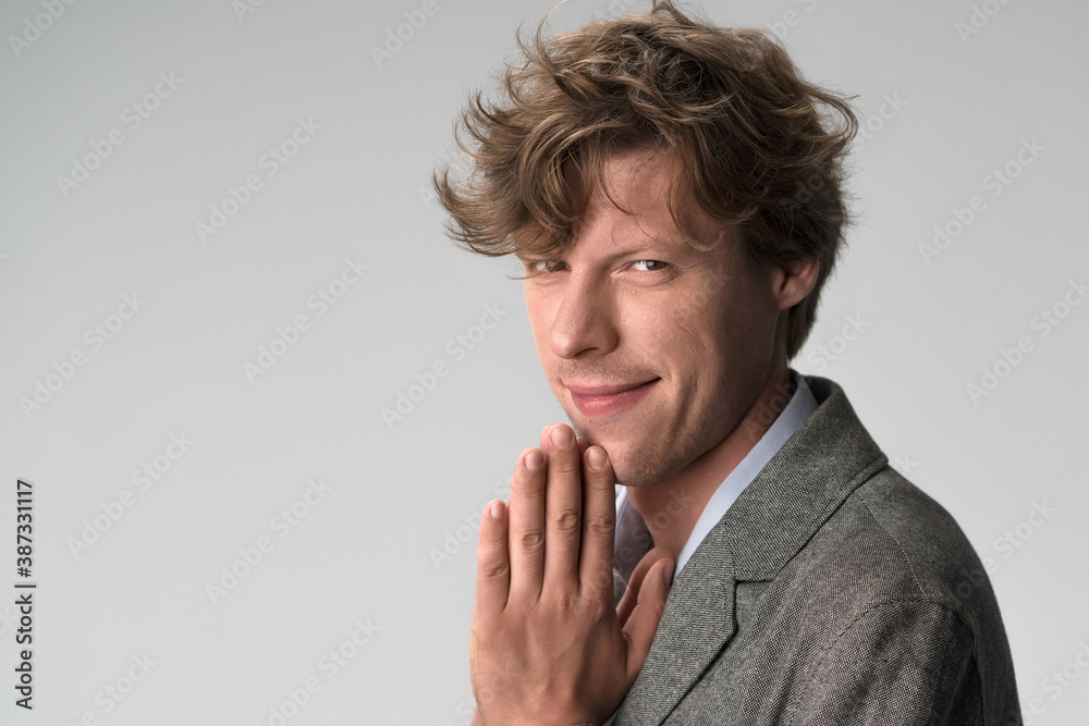 Kind request concept. Curly haired man cute smiling with folded palms ...