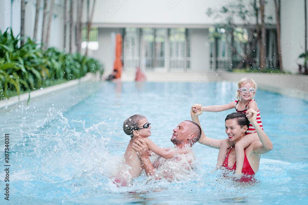 Vacation with a family. Happy young parents and their kids having fun ...