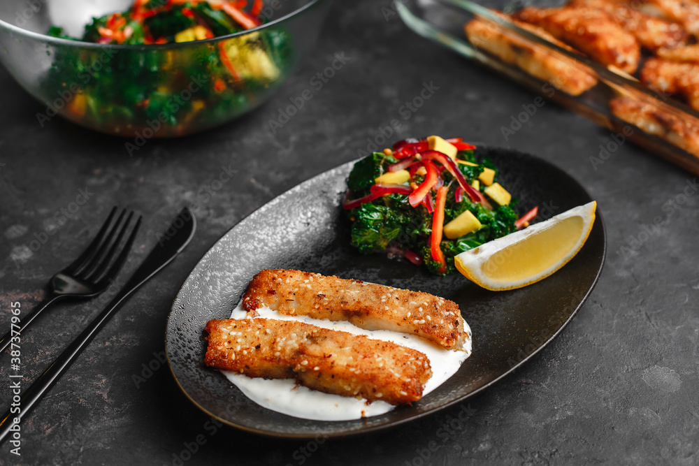 Pan-fried barramundi or pangasius. Breaded fish steak with sesame seeds ...