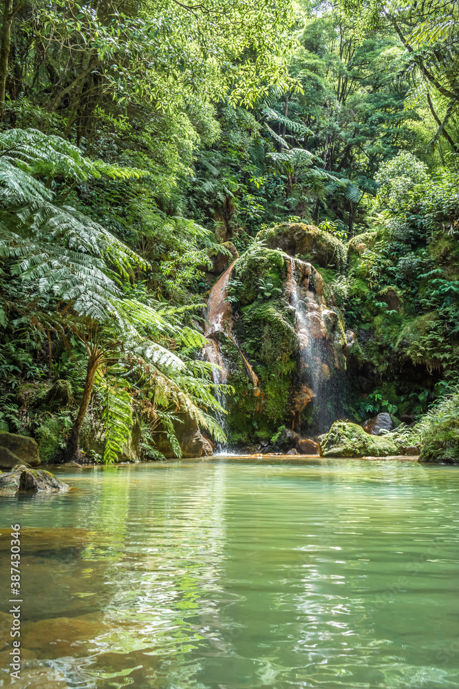 Thermal spring water cascading in the pool of the natural monument of ...