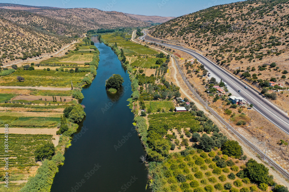 River separates the fields . Tuna river is one of the biggest river in ...