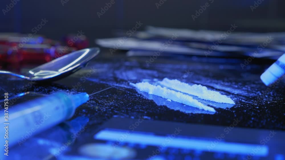 Man sniffs lines of cocaine through rolled dollars banknote against ...