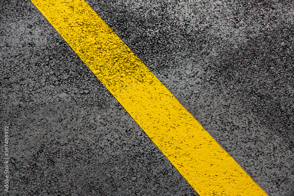 yellow markings of the new highway with tarmak road surface close up ...