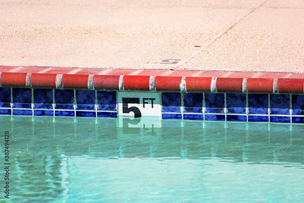 Swimming pool depth marker identifies the water depth for swimmers ...