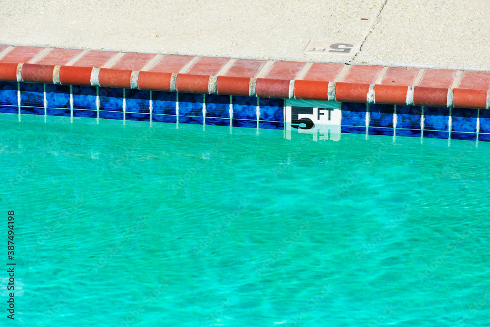 Swimming pool depth marker identifies the water depth for swimmers ... Swimming pool depth marker identifies the water depth for swimmers ...