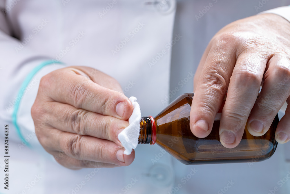 female nurse or doctor using alcohol liquid to make disinfection of her ...