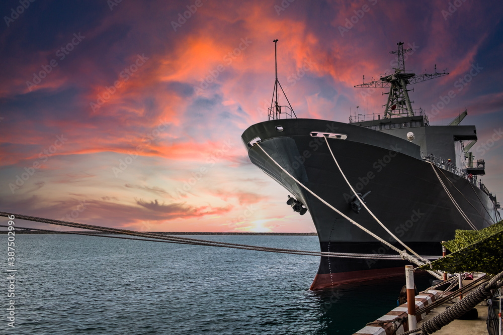 Military navy ship in the port. Gray modern warship with sunset in the ...
