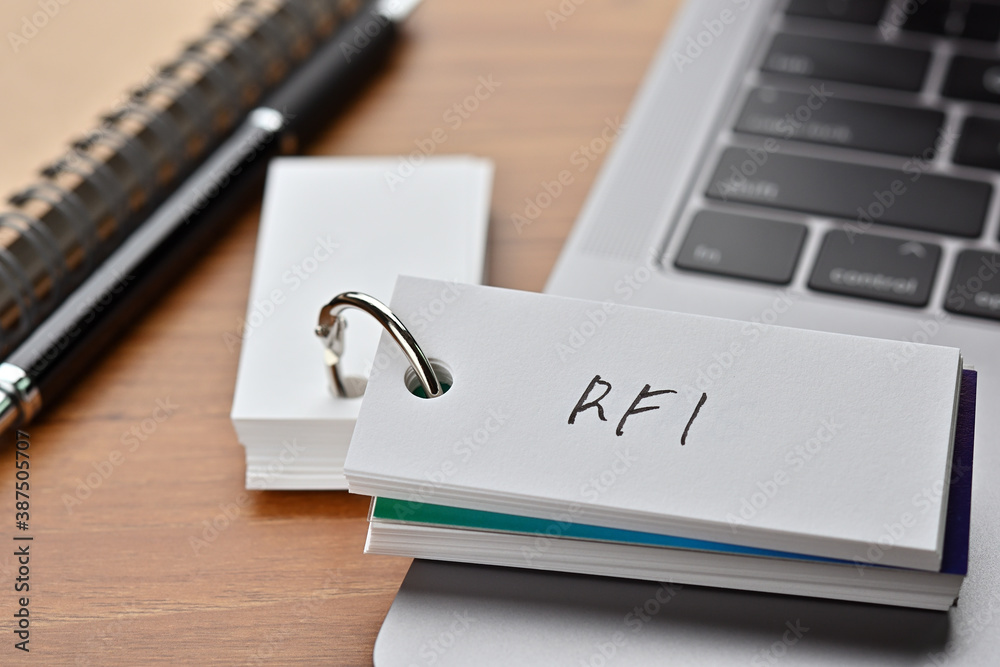 The words "RFI" written in a word book. Close-up. It is an acronym for ...