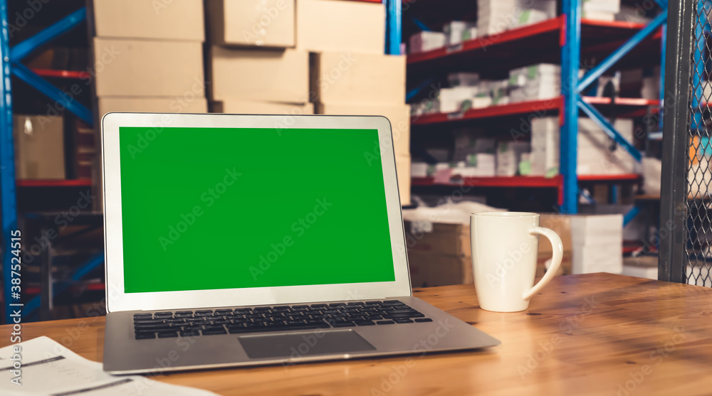 Computer with green screen display in warehouse storage room . Delivery ...