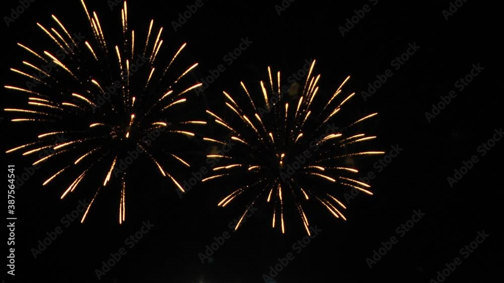 Out of focus fireworks light up the night sky. Red, white and blue ...