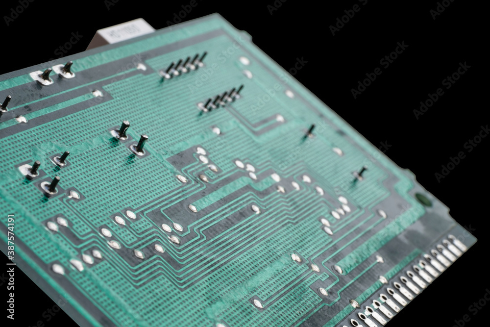 Green electronic circuit board with many electrical components ...