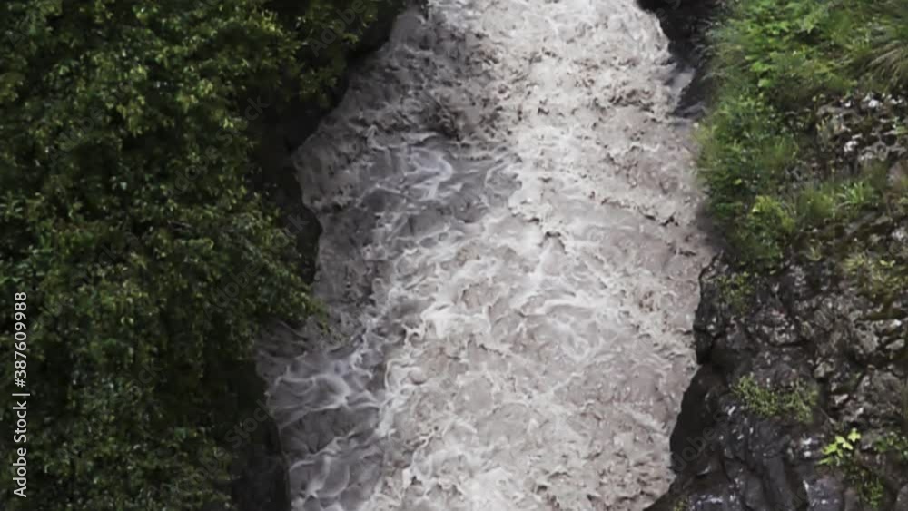 A powerful stream of water is squeezed between the sides of the rocks ...