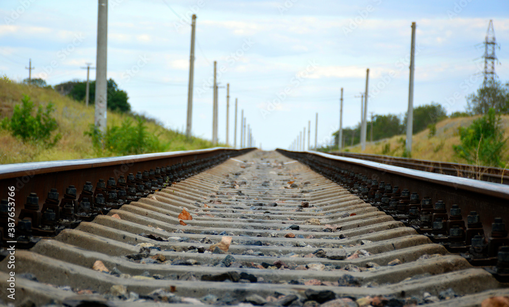 the track of the railway goes into the distance. rails and sleepers are ...