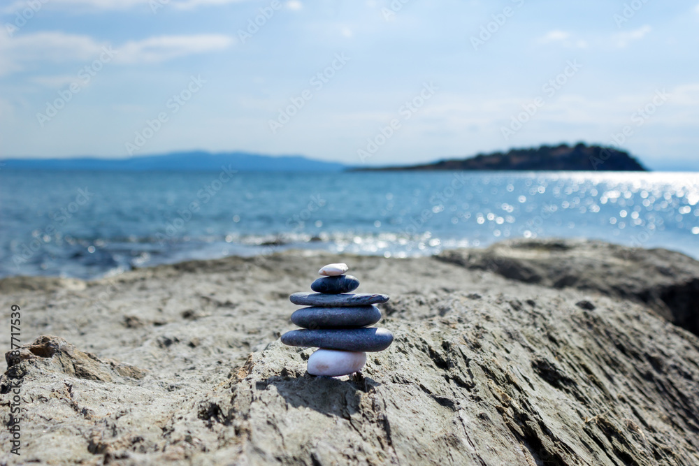 Pyramid of sea stones on the seashore at the pebble beach. Concept of ...