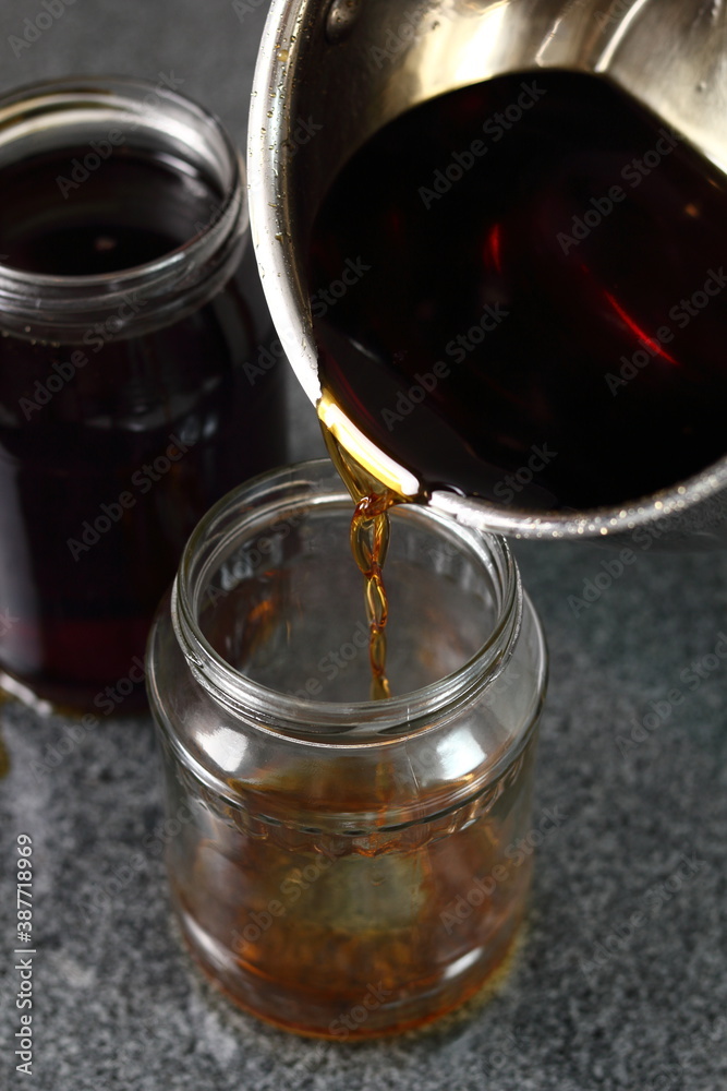 Pouring syrup into sterilised jars. Making Golden Syrup Series. Stock ...