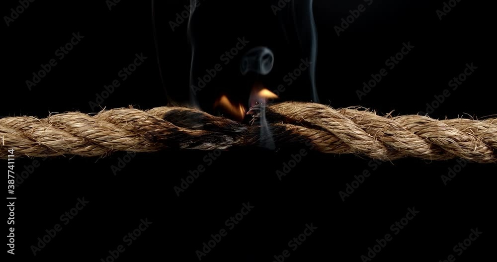 Rope stretched tight and slowly burning apart, finally snapping in two ...