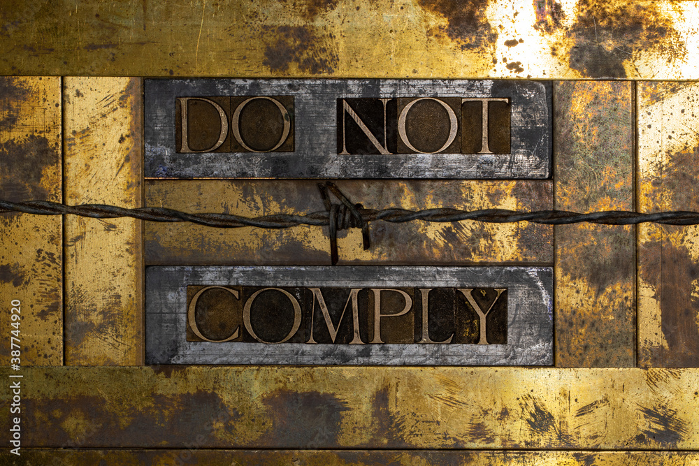 Do Not Comply text message on vintage textured grunge copper and gold background with barbed ...